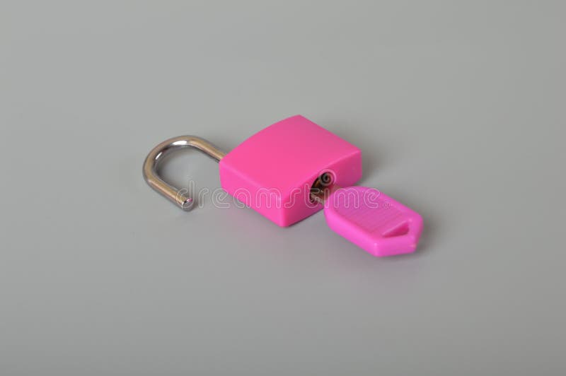 Pink Padlock and Key Isolated on a Grey Background. Copy Space for the ...