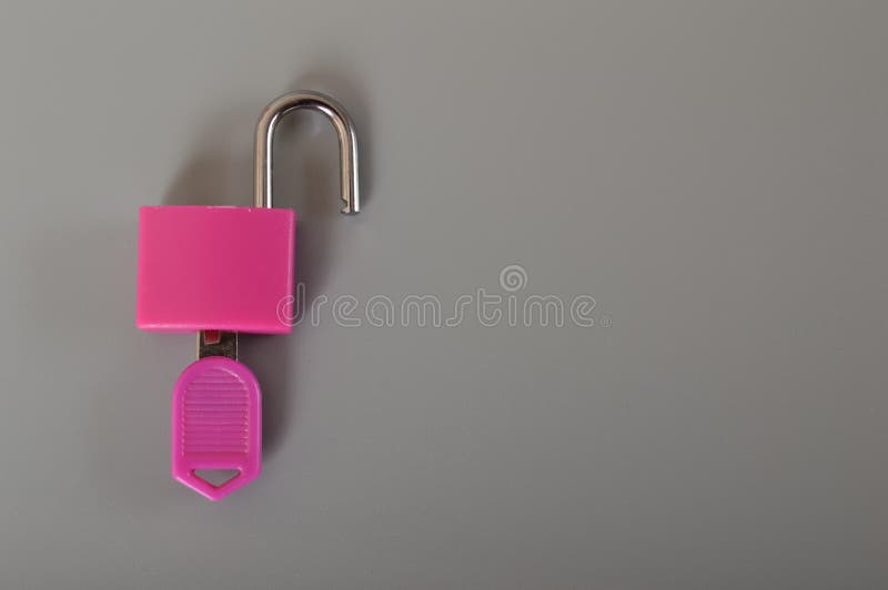 Pink Padlock and Key Isolated on a Grey Background. Copy Space for the ...