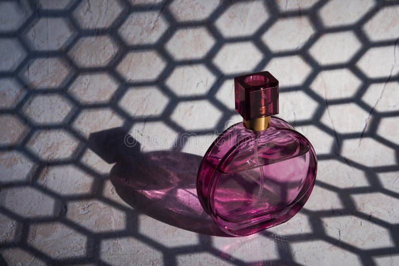 Pink Perfume Bottle with Reflections and Contrasting Shadows Stock ...