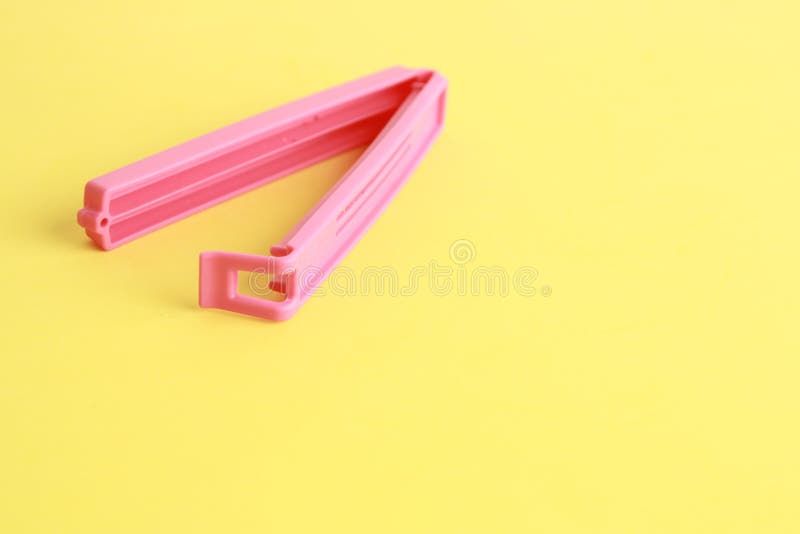 Pink Plastic Clip for Food Bags on a Yellow Surface Stock Image - Image ...
