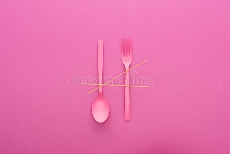 Pink Plastic Spoon Upside Down and Fork with Spaghetti Isolated on Pink ...