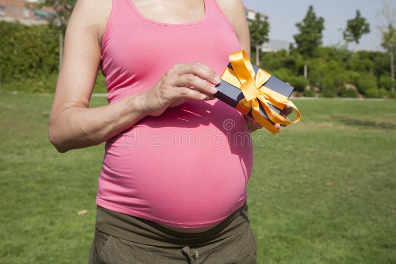 Pink pregnant with gift stock photo. Image of isolated - 46234588