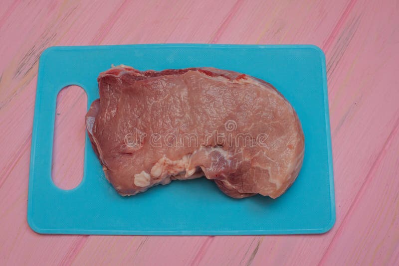 Pink Raw Pork Lie on a Blue Board. Appetizing Meat. Pork on Blue Board ...