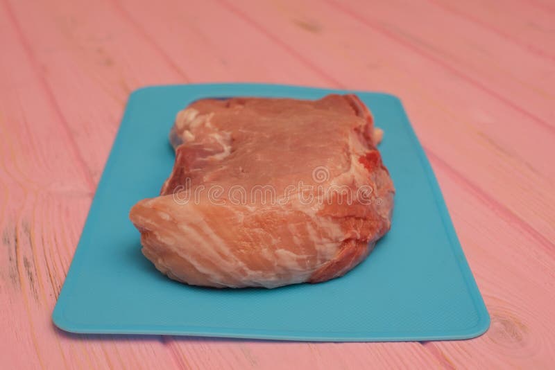 Pink Raw Pork Lie on a Blue Board. Appetizing Meat. Pork on Blue Board ...