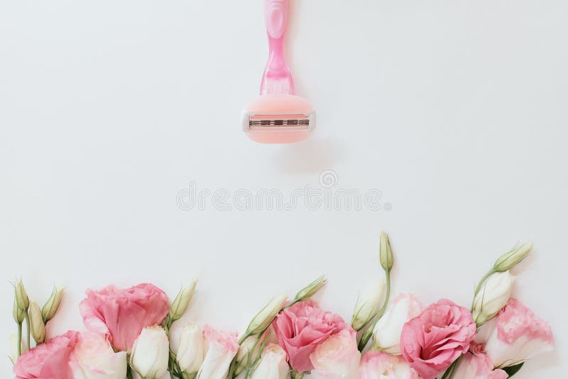 Pink Razor with Blades on a Light Gray Background with Rose Flowers at ...