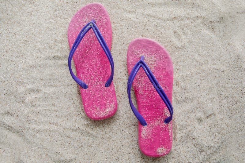 Pink sandal on sandy beach stock photo. Image of pair - 93230044