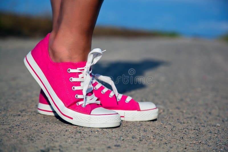 Pink sneakers on girl legs stock image. Image of shoe - 21488855