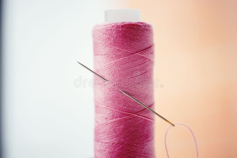Pink Spool of Thread and a Needle in it, Side View, Macro Photo Stock ...