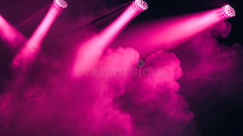 Pink Spotlights Illuminate Dense Smoke on a Dark Stage Backdrop with ...