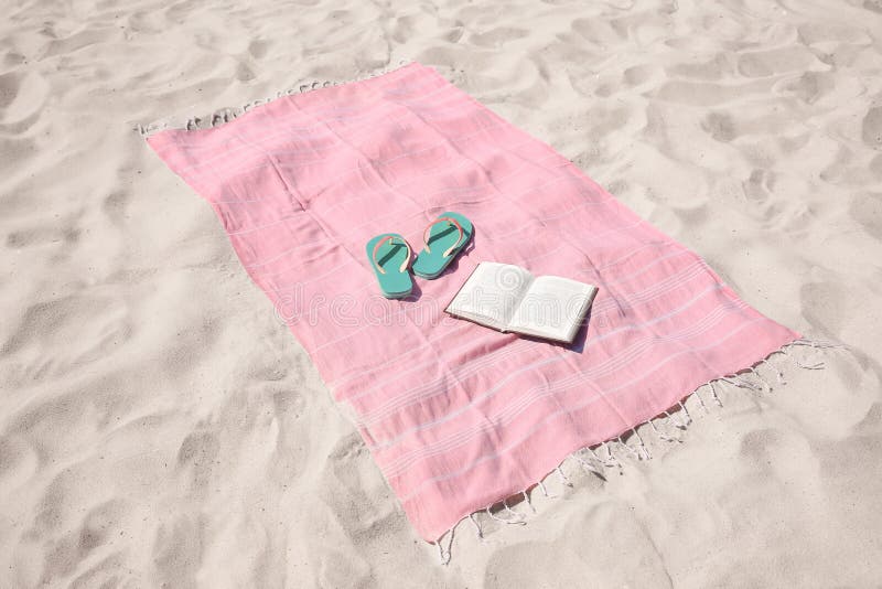 Pink Striped Beach Towel, Flip Flops and Book on Sand Stock Photo ...