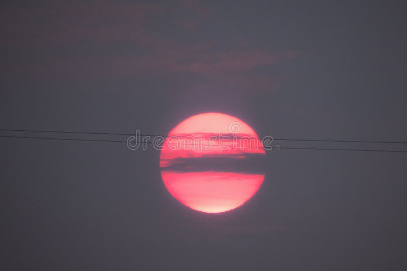 Pink Sun on grey sky stock photo. Image of captured - 225578706