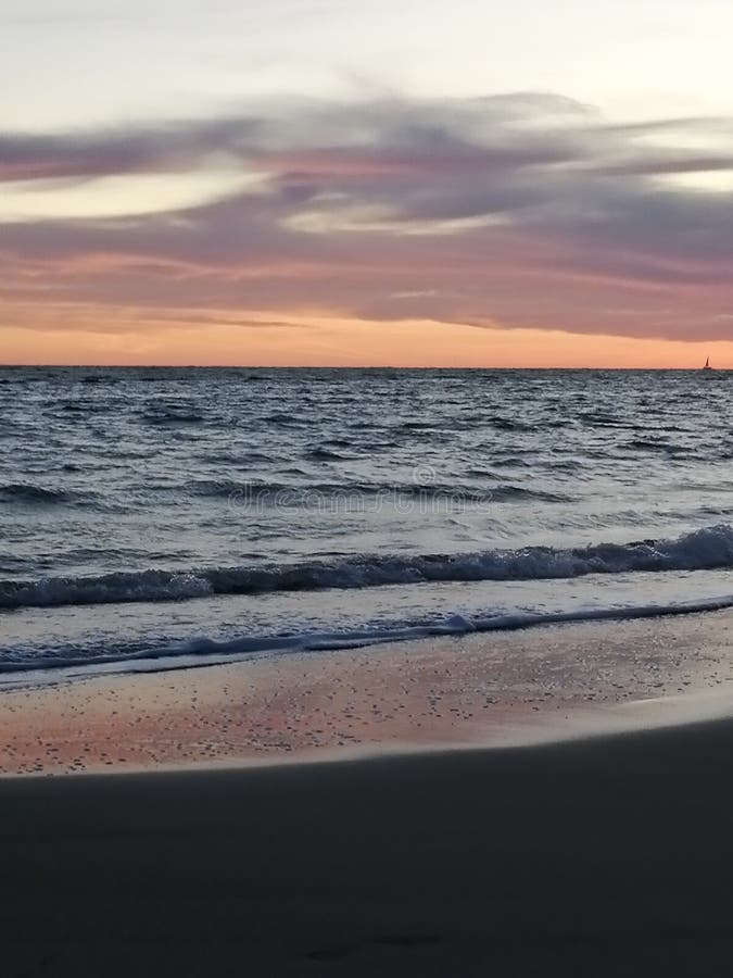 Pink sunset on the beach stock image. Image of live - 185525121