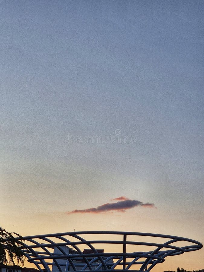 Sunset in the Sky. Unusual Cloud Over Modern Architectural Structure ...