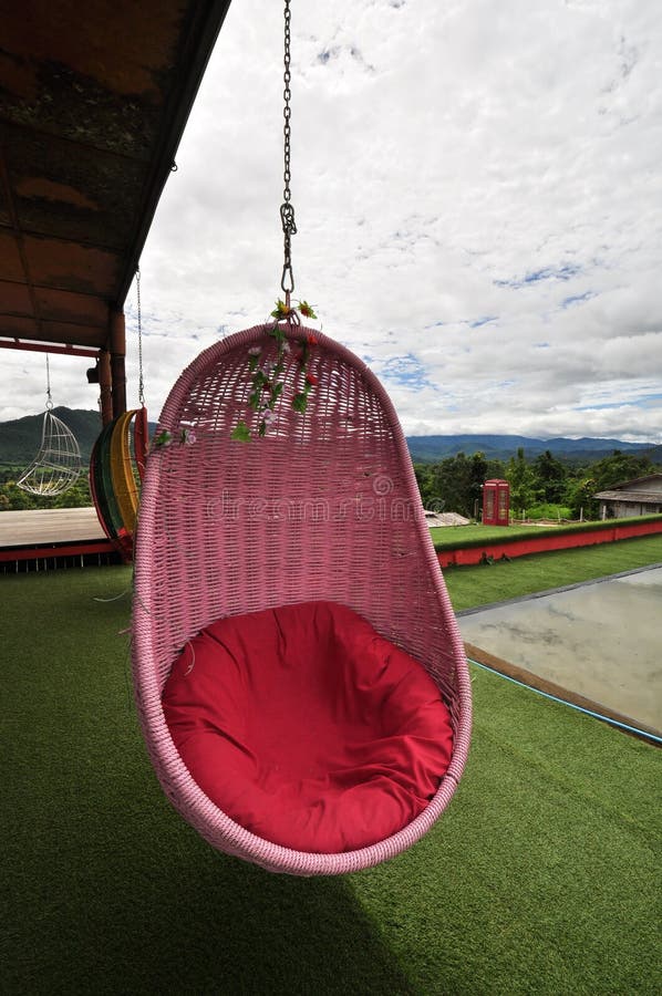 Pink old swing in garden stock image. Image of rust - 209470417