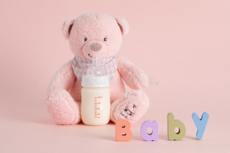 Pink Teddy Bear and a Bottle of Formula on a Pink Surface Stock Image ...