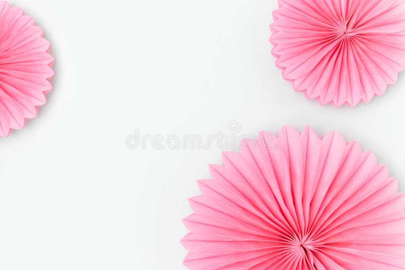 Pink Tissue Paper Fans Scattered on a Blue Background. Stock Photo ...