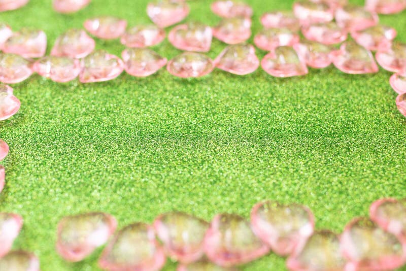 Pink Transparent Plastic Hearts on Green Glittering Background. Stock ...