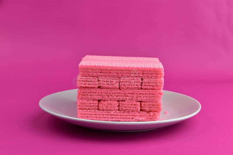 Pink Wafers on a White Plate with a Pink Background Stock Image - Image ...