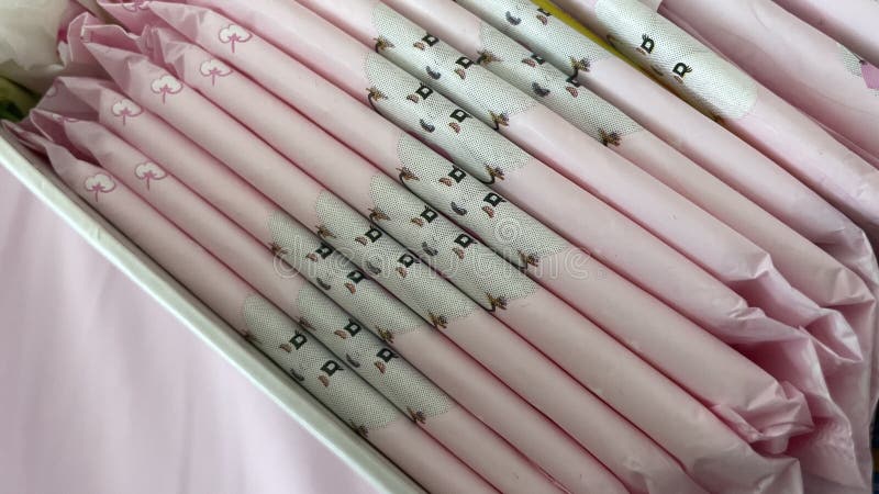 Pink and White Hygienic Pads in Pink Packaging with White Smiles in a ...