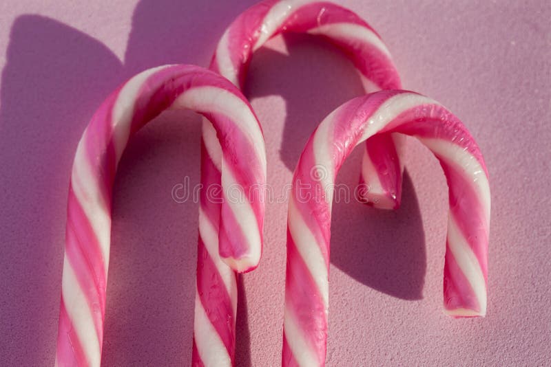 Pink and White Striped Candy Canes on a Pastel Background Stock Photo ...
