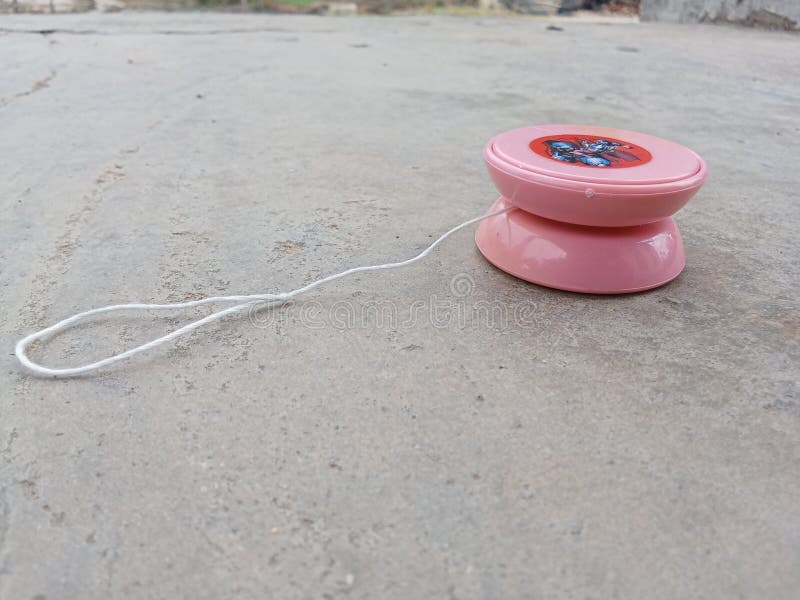 A Pink Yo-yo with a String is a Traditional Children& X27;s Play Tool ...