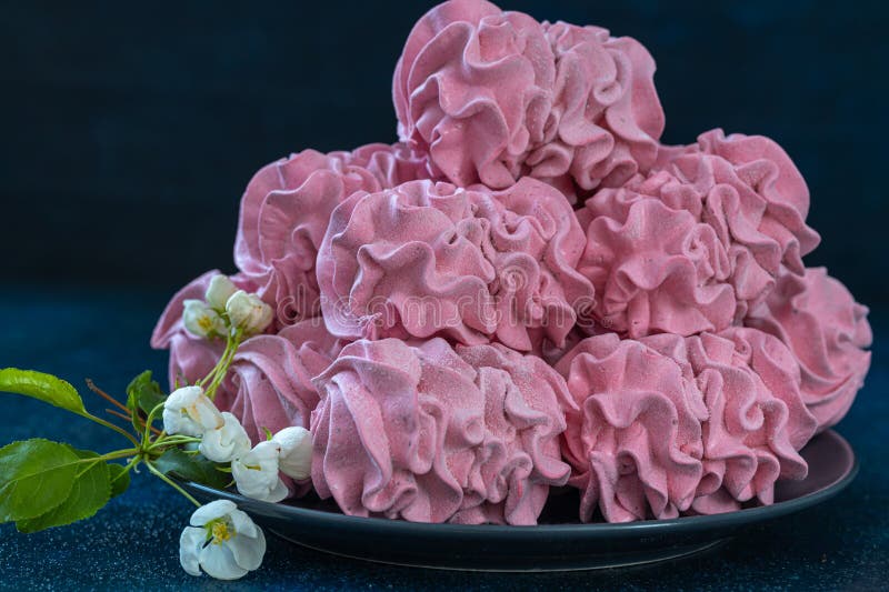 Pink Zephyr on a Plate on a Dark Blue Background Stock Image - Image of ...