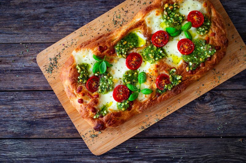 Pinsa Romana with Mozzarella Cheese and Basil Pesto on Wooden Table ...