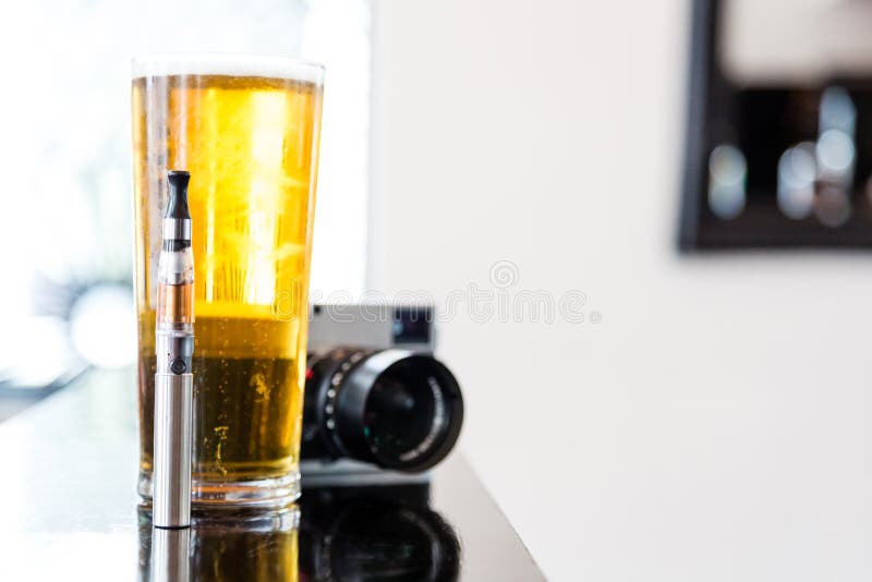 Pint of Beer with an E-cigarette and Camera Stock Photo - Image of ...