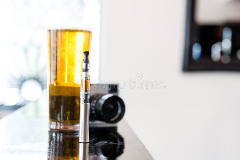 Pint of Beer with an E-cigarette and Camera Stock Image - Image of ...