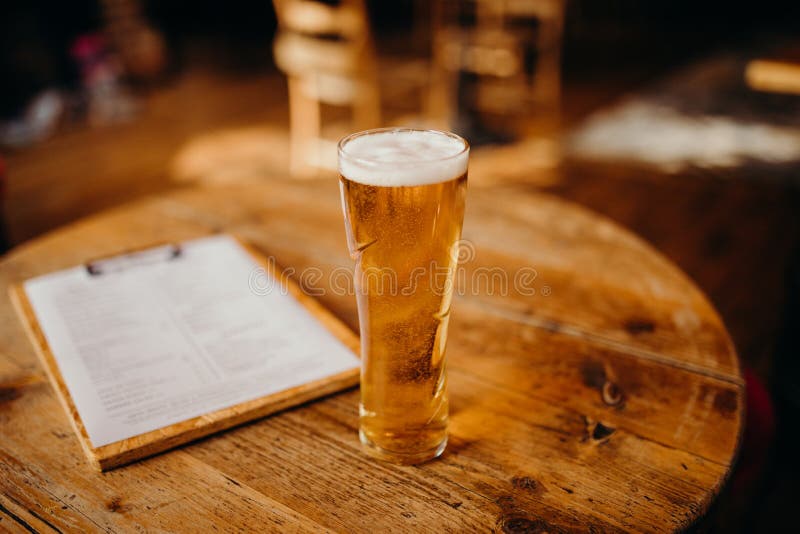 Pint of beer on a table. stock photo. Image of brewery - 132625518