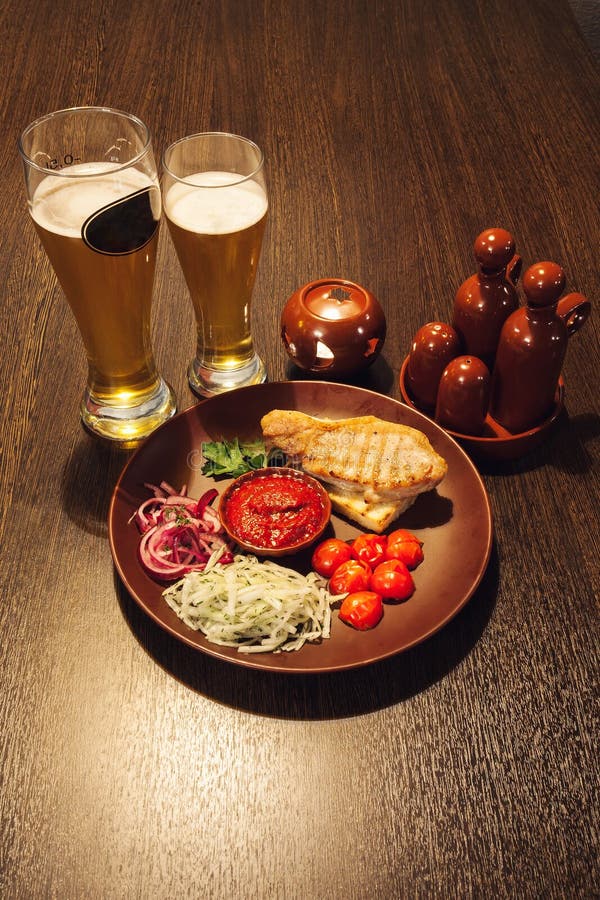 Pint of Beer with Tomatoes and a Meat Stake on the Table Bar in Pub ...