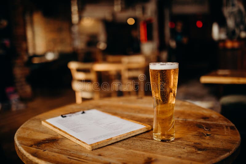 Pint of beer on a table. stock photo. Image of amber - 132625694
