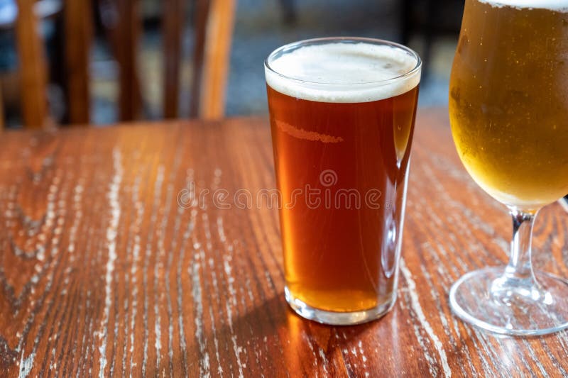 Pint Glasses Of British Ale And Lager Beer Served In Old Vintage English Pub Stock Image Image