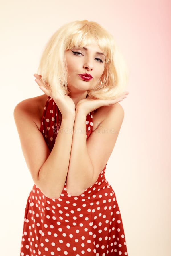 Pinup Girl In Blond Wig Retro Dress Blowing A Kiss Stock Image Image