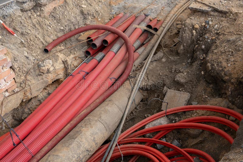 Pipe and Cables in Red Corrugated Pipe are Buried Underground on the ...