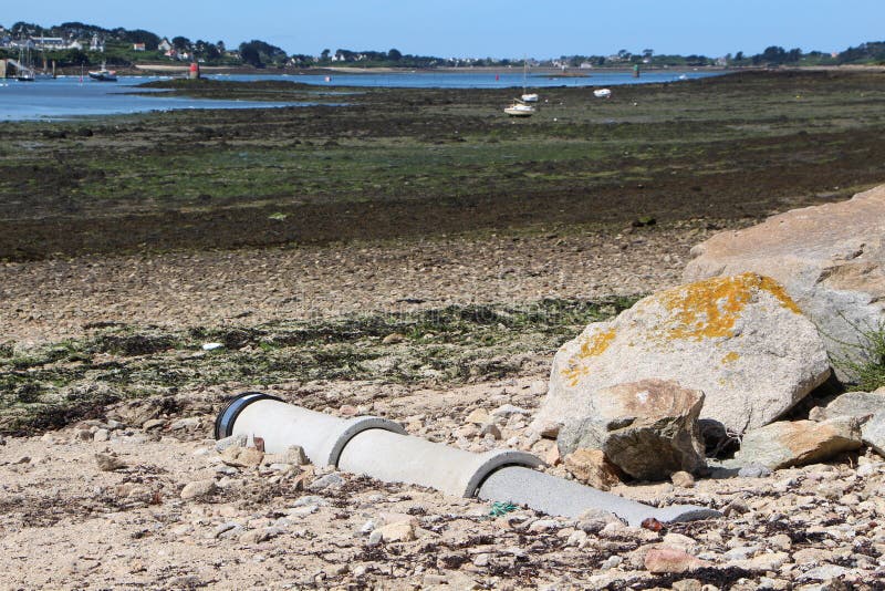 Pipe come out onto a beach stock photo. Image of buried - 85646968