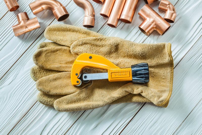 Pipe Cutter on Construction Glove and Fittings Stock Photo - Image of ...