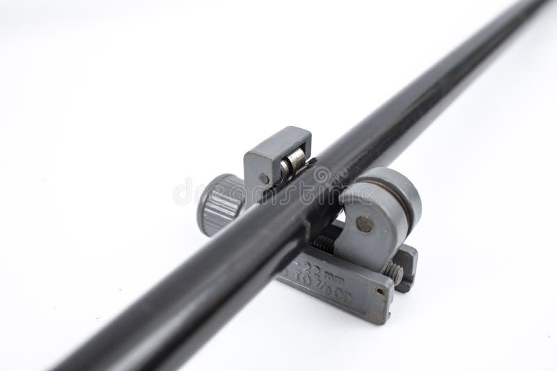 Pipe Cutting Tool on a Black Coated Copper Pipe, Isolated on White ...
