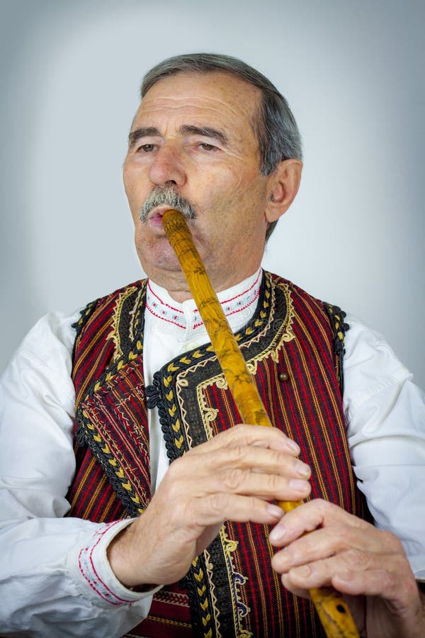 Pipe Player in Traditional Clothing Stock Photo - Image of color, toned ...