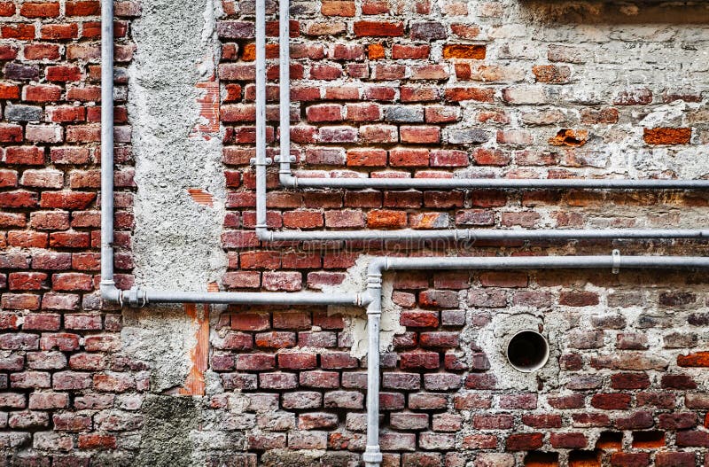 Pipeline on brick wall stock photo. Image of modern - 134020136