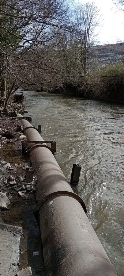 Pipeline on the Side of the River Stock Image - Image of bridbe, rock ...