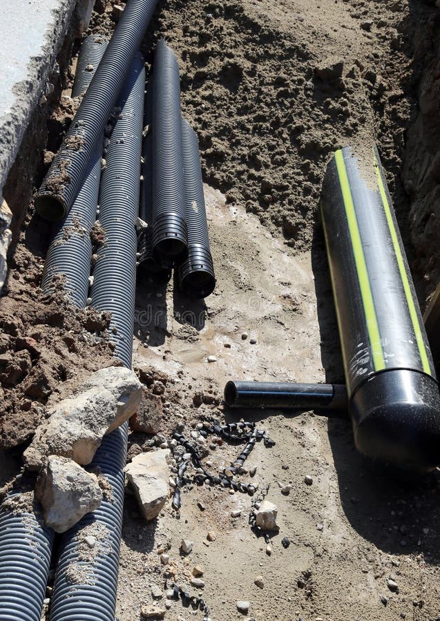 Pipes and a Big Gas Pipeline Inside the Excavation in Road Const Stock ...
