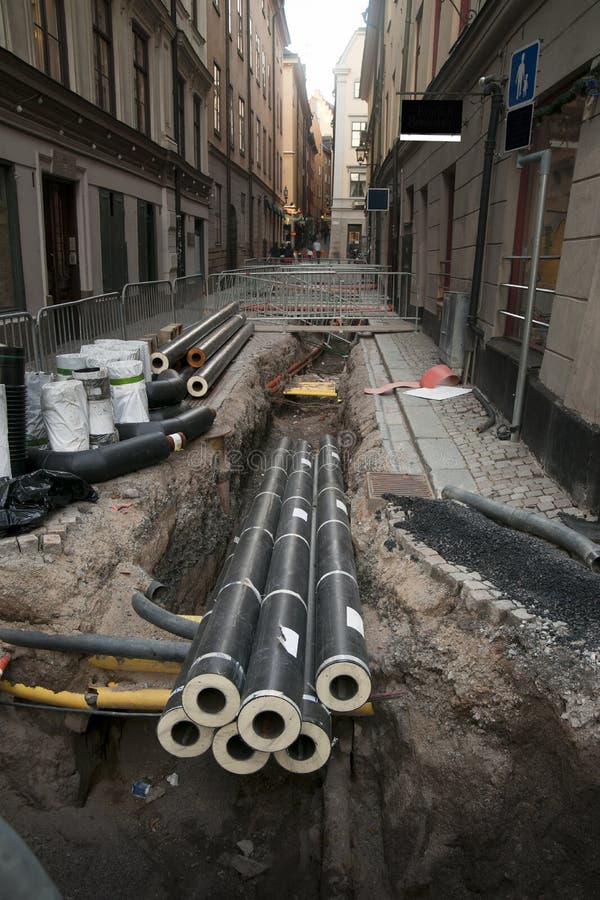 Pipes in dug up street stock photo. Image of insulated - 21410326