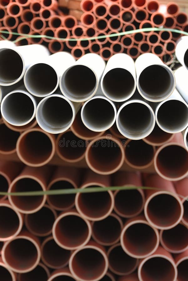Stack of PVC pipes stock image. Image of construction - 233974617