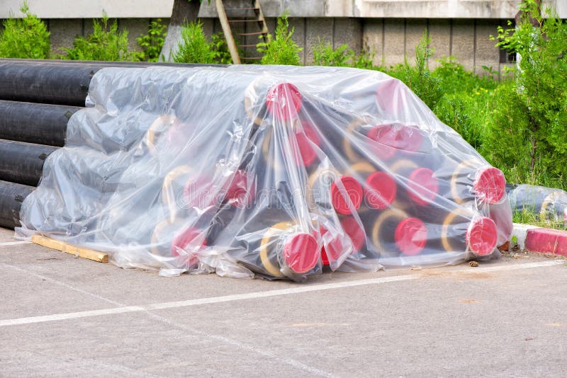 Pipes wrapped in plastic stock photo. Image of piled - 55615452