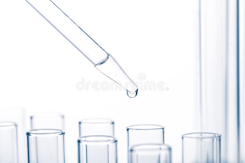 Pipette with a Drop and Scientific Laboratory Test Tubes in a Research ...