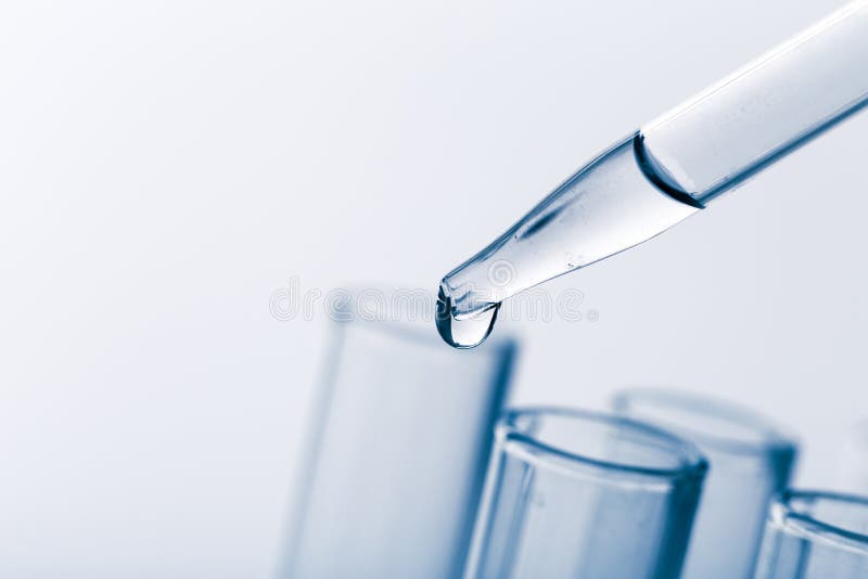 Pipette with a Drop and Scientific Laboratory Test Tubes in a Research ...