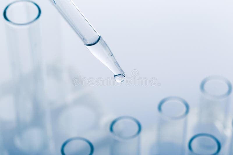 Pipette with a Drop and Scientific Laboratory Test Tubes in a Research ...