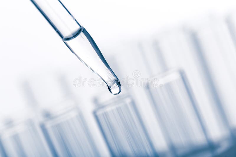 Pipette with a Drop and Scientific Laboratory Test Tubes in a Research ...