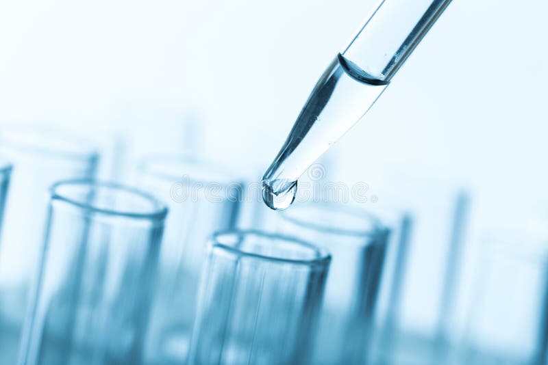 Pipette with a Drop and Scientific Laboratory Test Tubes in a Research ...